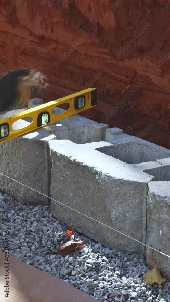 Construction worker was mounting concrete blocks to retaining wall on ...