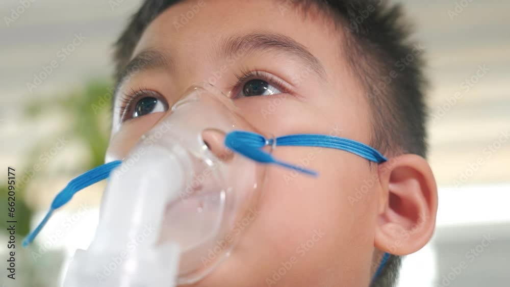 Asian Child using nebulizer mask equipment alone have smoke, Kid boy ...