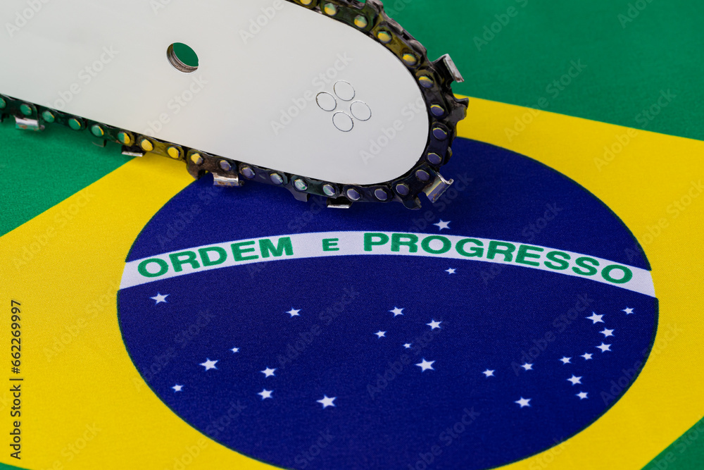 Brazil flag and chainsaw. Deforestation, rainforest destruction and ...