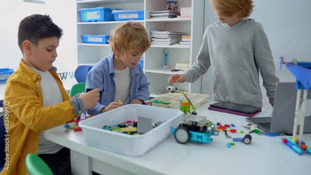 Robotics programming class. Children construct and code Robot. STEM ...