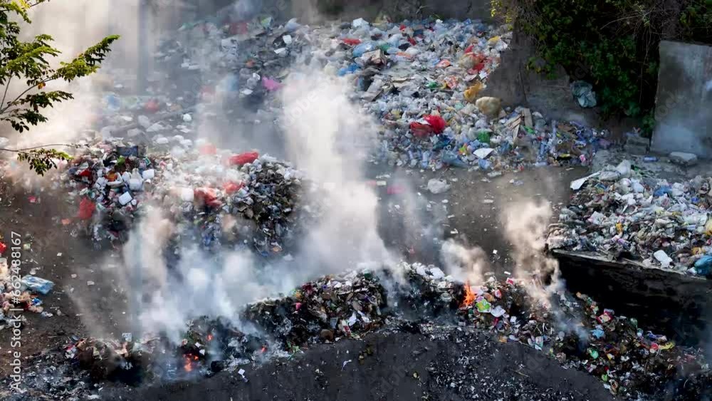 Garbage and fire burn in landfill. Also call trash, waste, rubbish ...