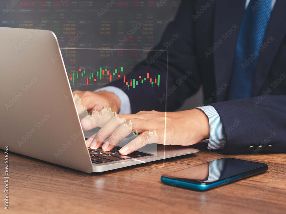 Businessman or trader reading documents and analysis graph candlestick ...