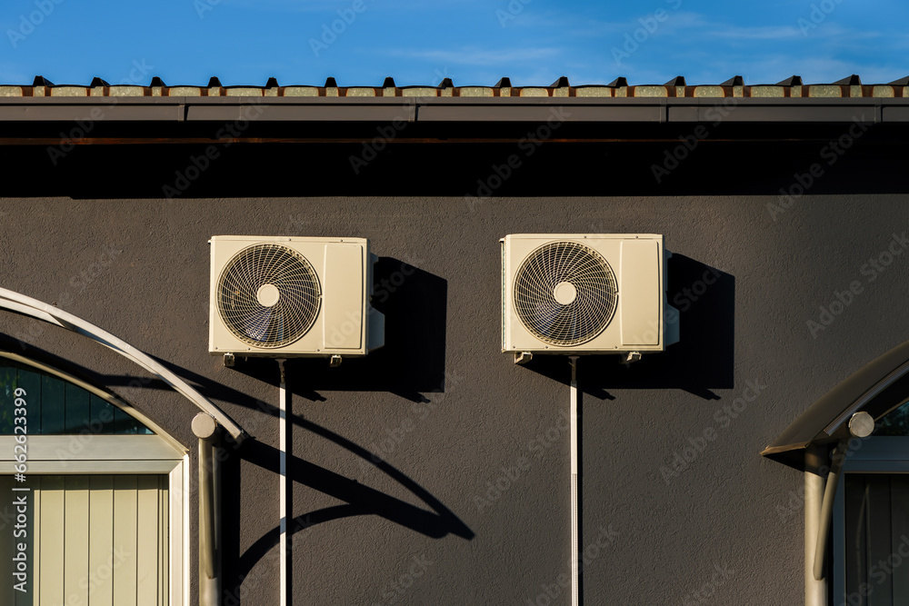 Air conditioner external units mounted on building wall. Heat pumps air ... Air conditioner external units mounted on building wall. Heat pumps air ...