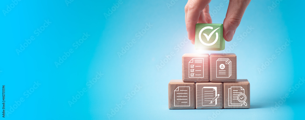 Hand holding white correct sign mark on blue wooden block cube and the ...
