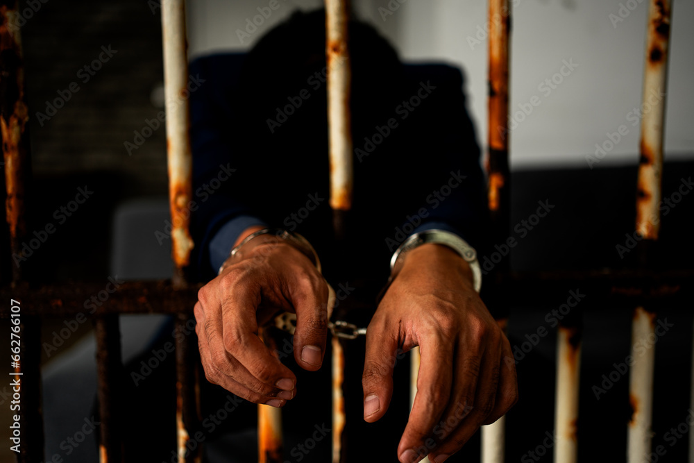 Asian businessmen wear handcuffs in jail after arrest because of ...
