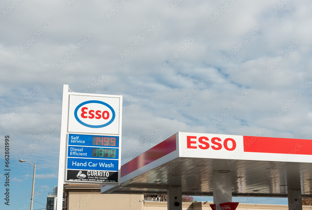 exterior pylon sign and station signage with cost of fuel on a cloudy ...