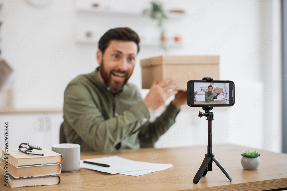 Caucasian bearded man making surprised facial expression while ...