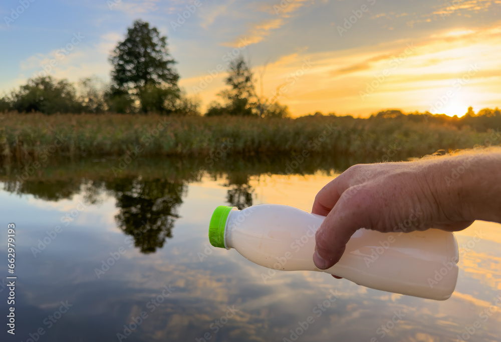 Man throwing plastic garbage in lake. Marine plastic pollution from ...