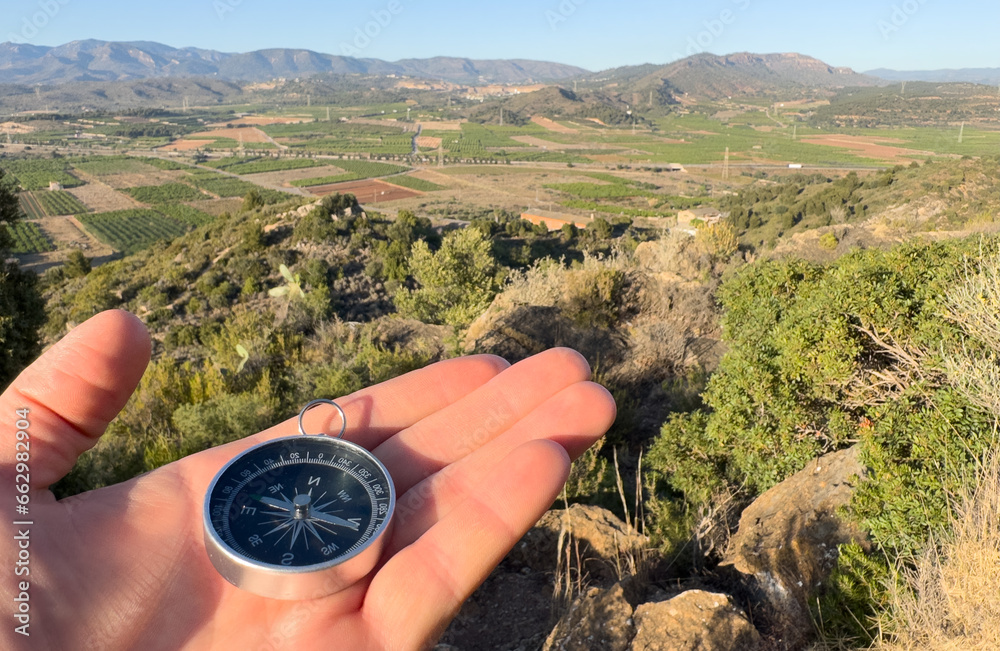Compass in hand in mountains. Tourist compass for orientation on ...