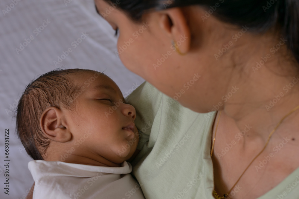 Newborn baby and his mother holding and looking at him. Normal vaginal cesarean delivery ...
