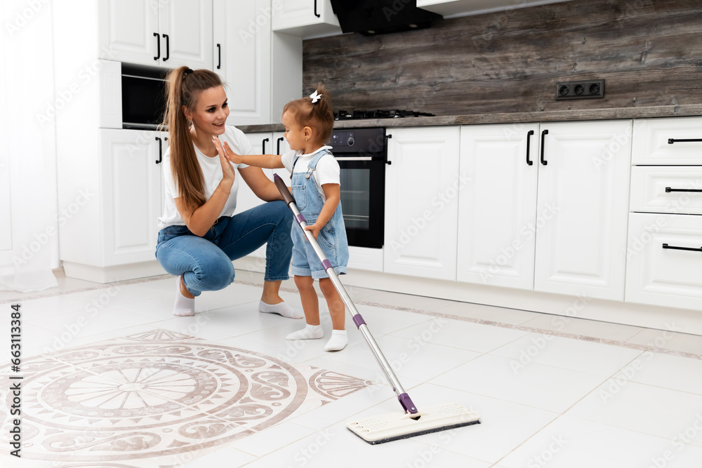 Good job. Cute little girl gives five mom after cleaning the house. A ...