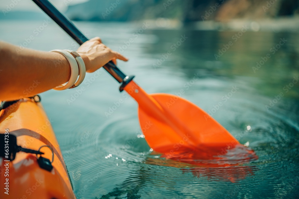 Kayak paddle sea vacation. Person paddles with orange paddle oar on ...
