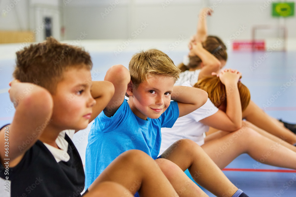 Group of children doing sit-ups in elementary school gym Stock Photo ...