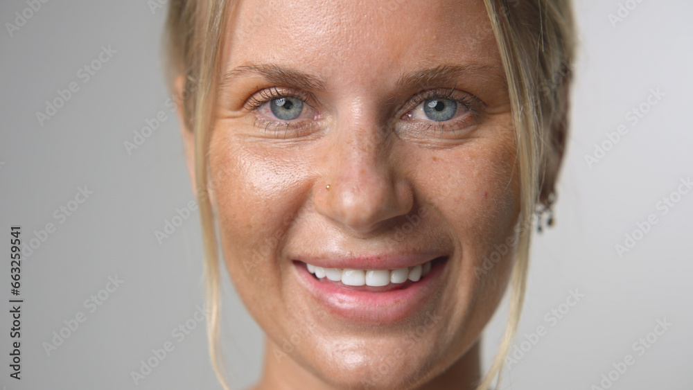 Beautiful person look at camera close up. Young adult woman face ...