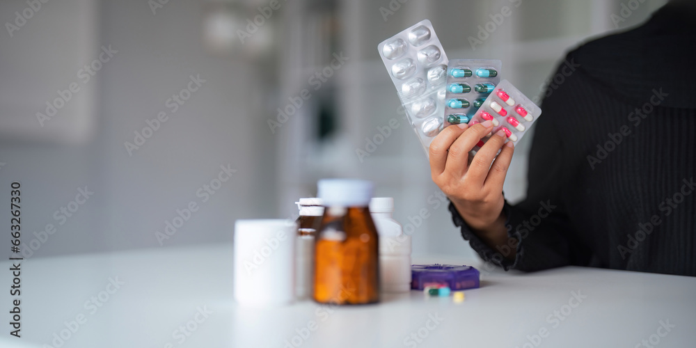 Woman hold bottle of drug tablet painkiller or vitamin supplement ...