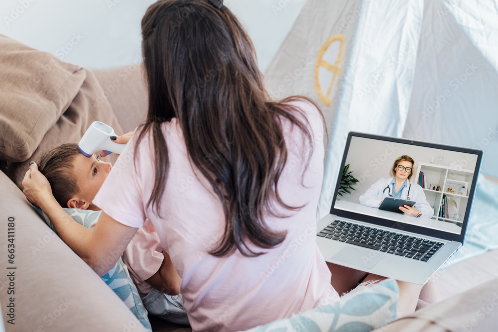 Poster Back view mother measures temperature of the child with non-contact digital infrared ...