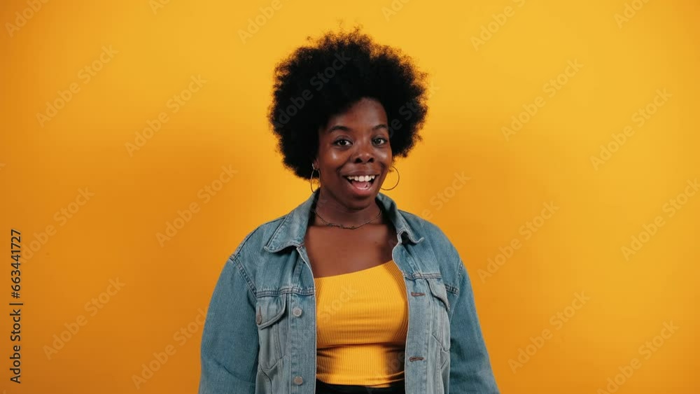 Young Afro American woman looks with surprised cheerful expression at ...