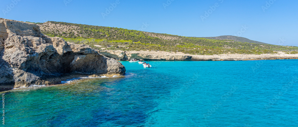 blue lagoon in the Aphrodite bathing area with caves in the rocks next ...