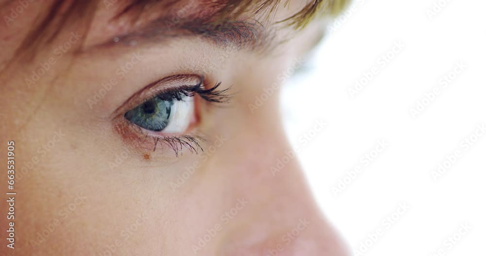 Profile closeup of a woman with blue eyes in studio with her pupils ...