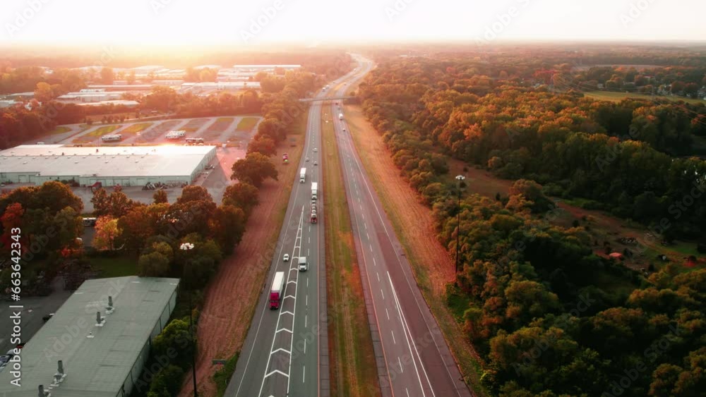 Magic sunset aerial views of trucking freight transported by semi truck ...
