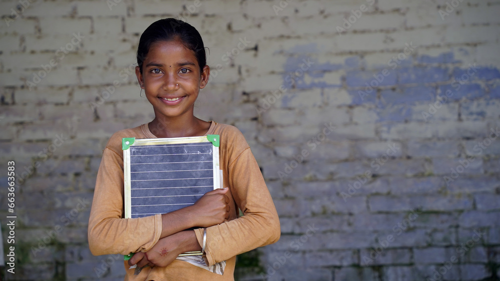 Rural School girl holding slate with English alphabet. Indian child ...