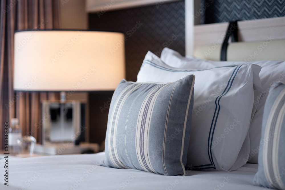 Crisp, fresh bedding on a king size bed in a hotel room. The bed is ...