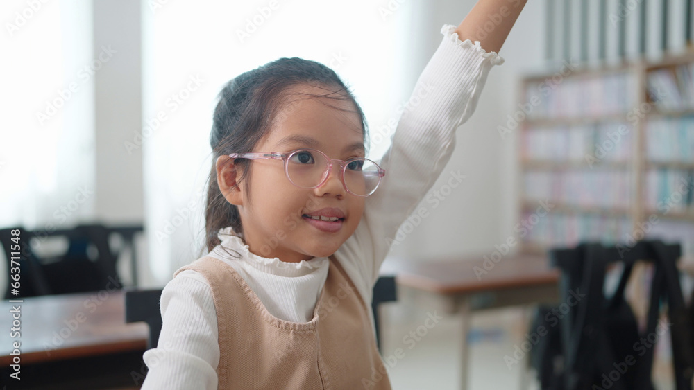 Foto de Active excellent Asian student schoolgirl in glasses raising ...