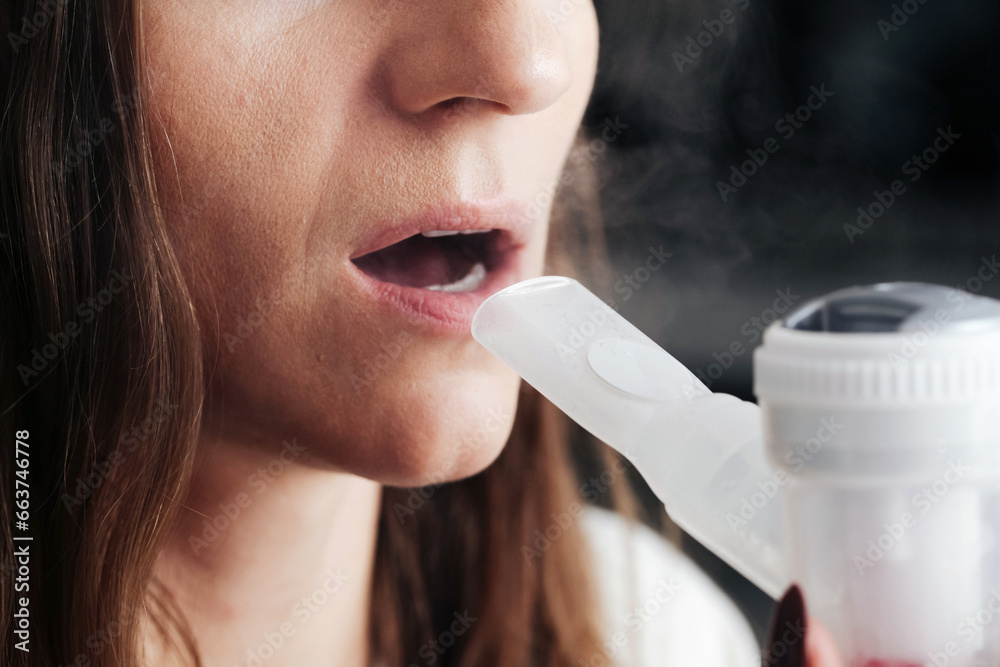 Nebulizer device in mouth. Woman with inhaler in her mouth background ...