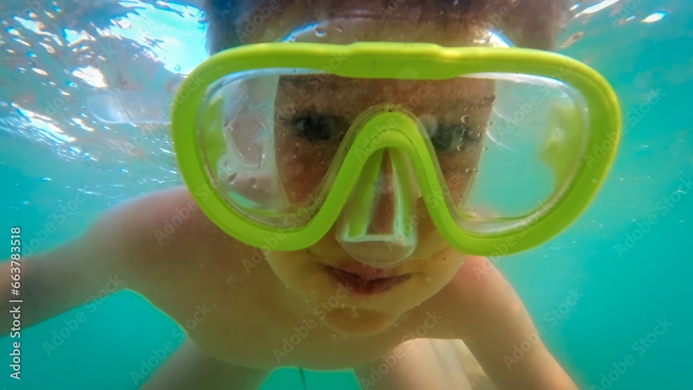 Little boy wearing snorkeling mask swimming underwater and exploring ...