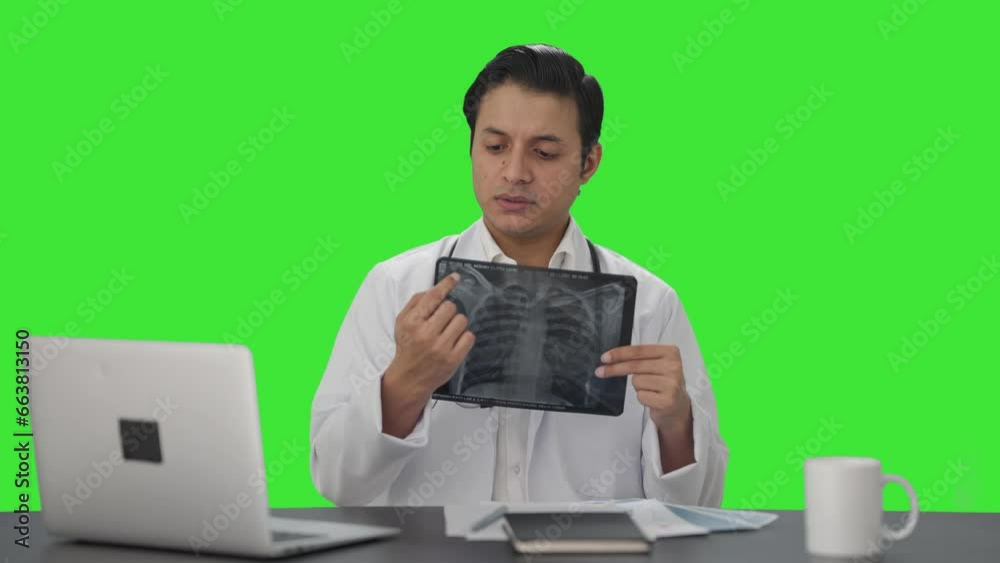 Sad Indian doctor explaining X ray report to the camera Green screen ...
