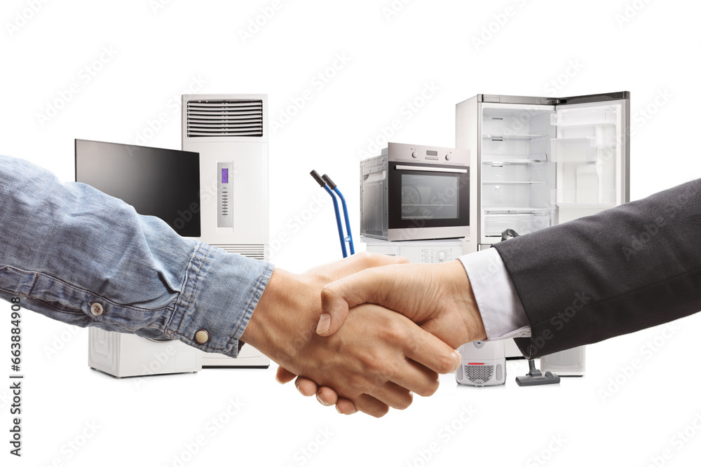 Salesman and a customer shaking hands in front of electrical appliances ...