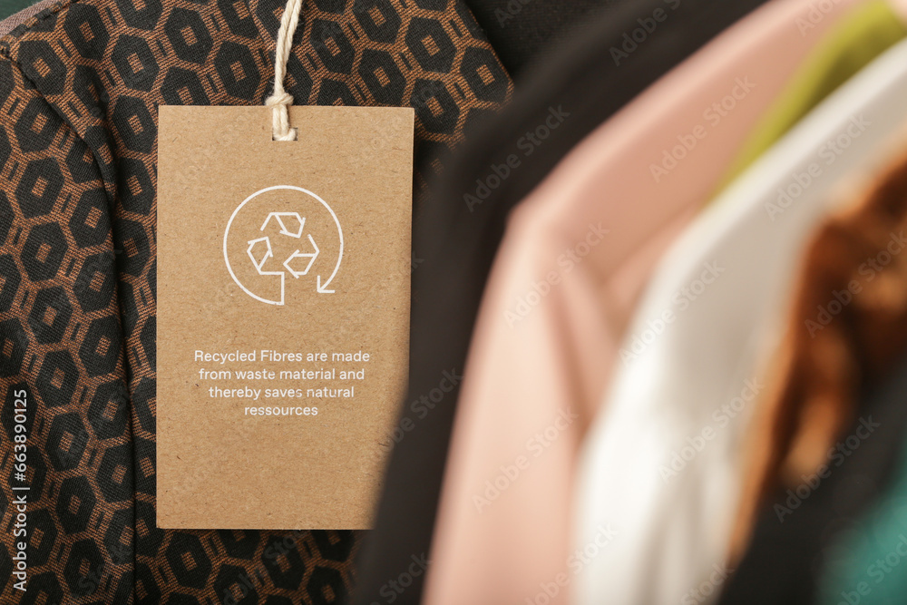 Close up of clothing tag with recycle icon. Recycling products concept ...