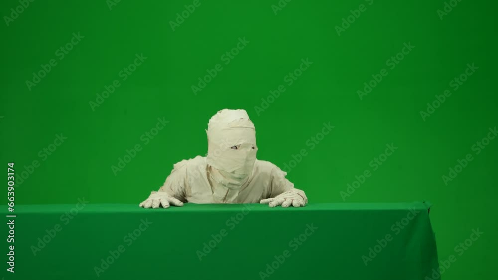 Green screen isolated chroma key video capturing a mummy rising from ...