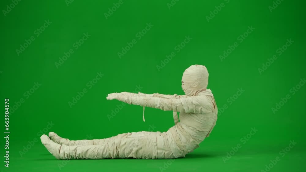 Green screen isolated chroma key video capturing a mummy rising from ...