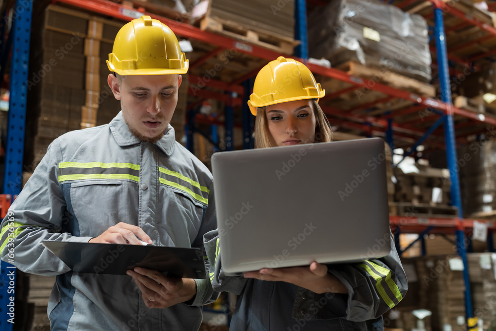 Male and female warehouse worker working and discussing in warehouse ...