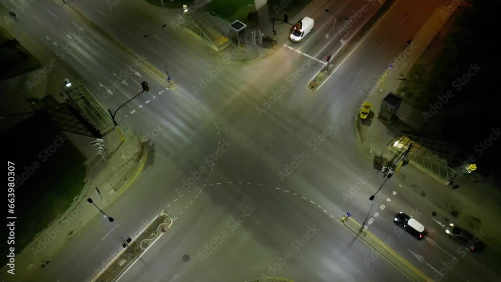 Aerial 4k footage of nighttime intersection with traffic lights. Cars ...