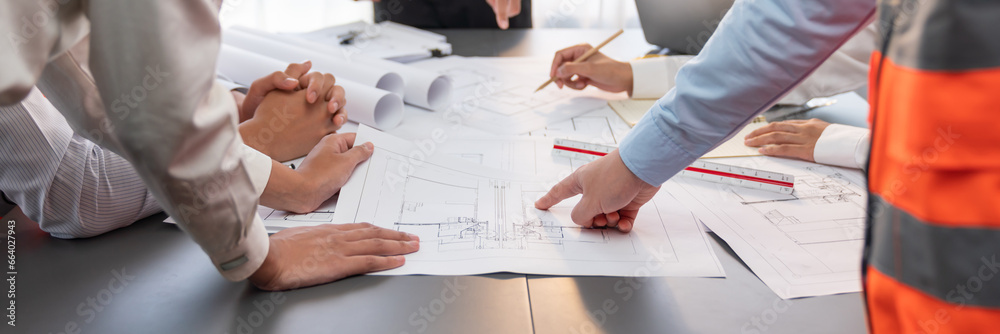 Engineer partner drawing and working on blueprint design together on ...