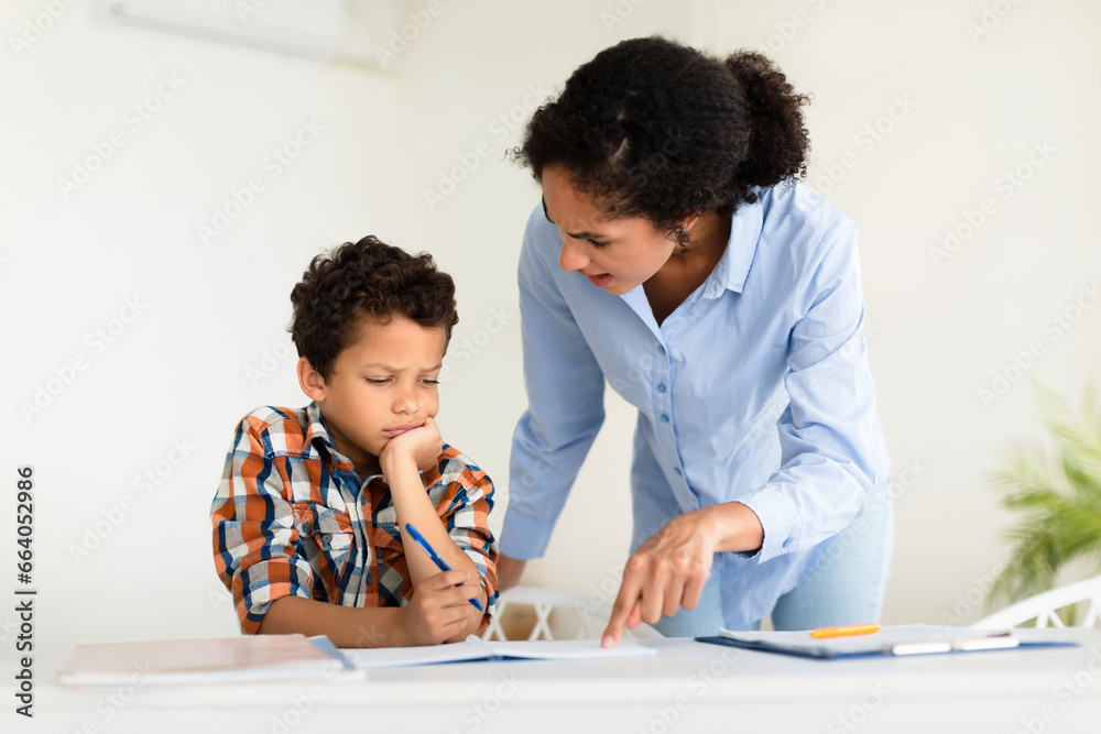 Angry teacher lady scolding pupil boy in class Stock Photo | Adobe Stock