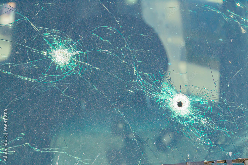 bullet wounds on a car window. gun attack on a car. gangs and conflicts ...