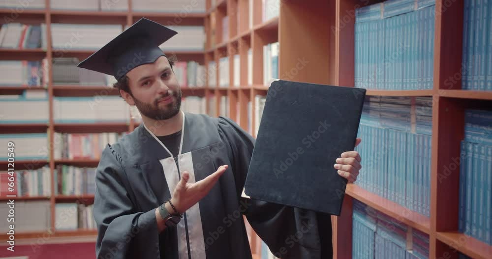 Happy male Student showing his graduated diploma as if it was nothing ...