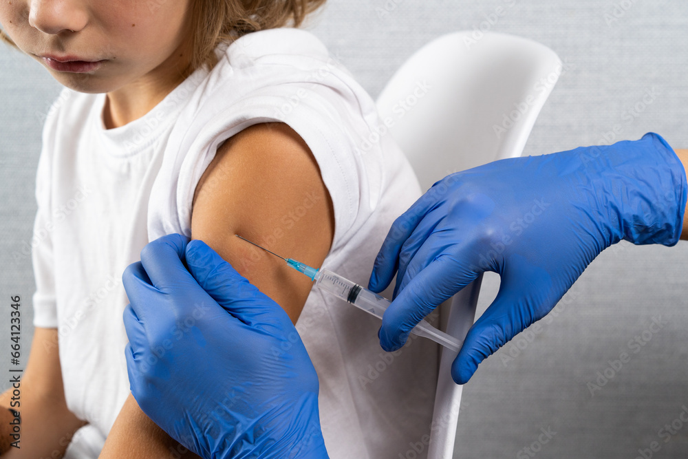 vaccination of children, a little boy at a doctor's appointment, an ...