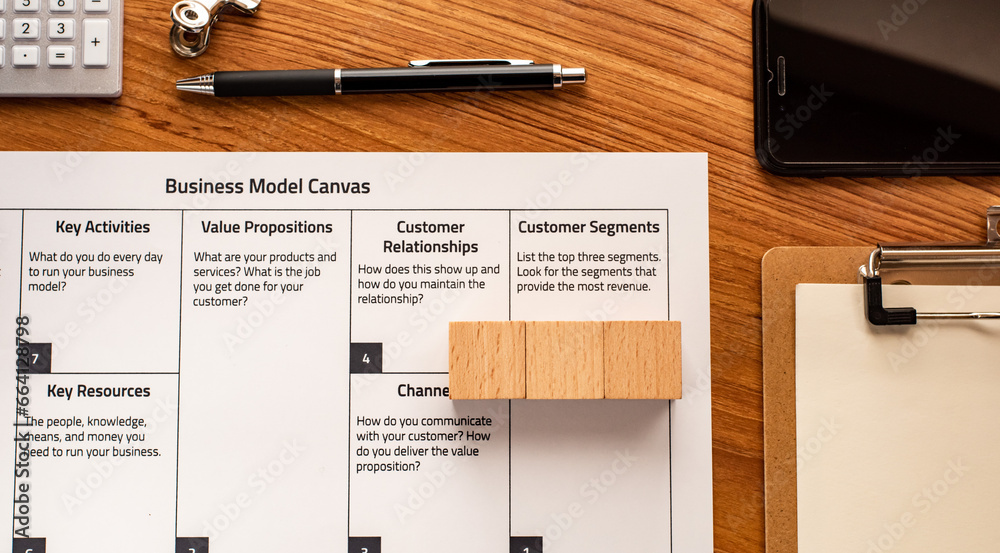 There is a desk there with dummy documents about Business Model Canvas ...