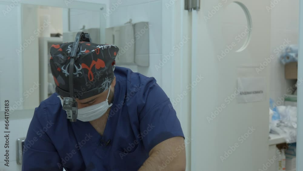 Doctor disinfects and washing his hands dry before entering the ...