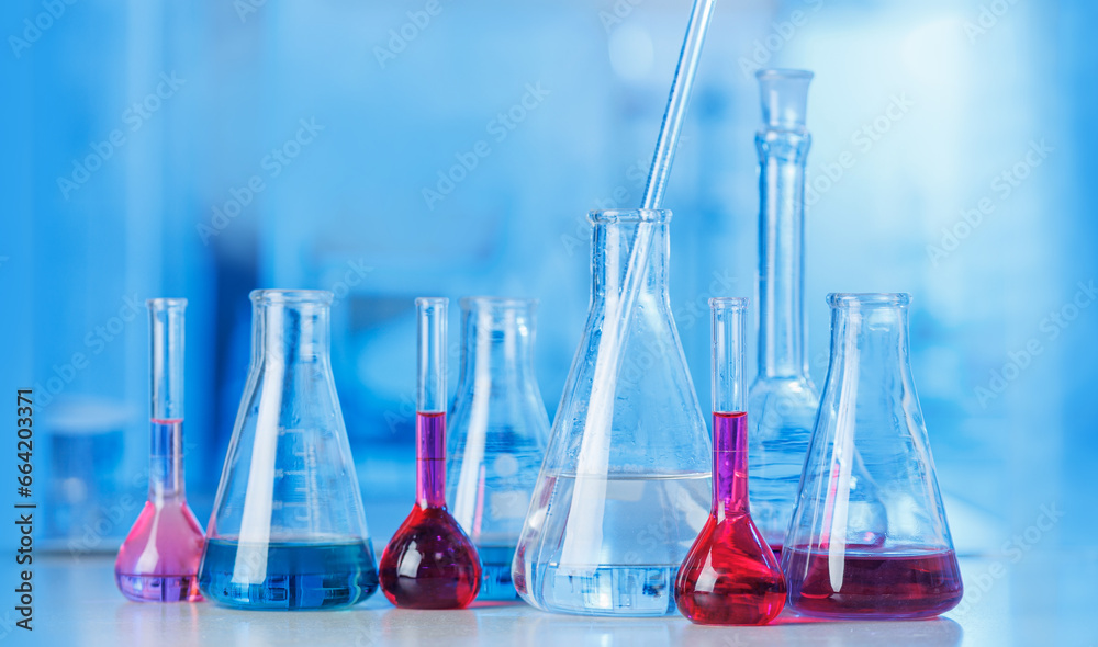 Purple and blue color glass flask in white light background. Concept ...