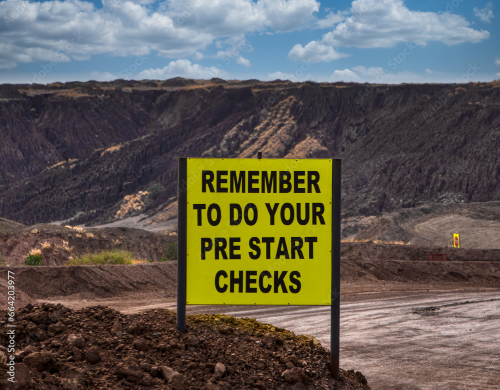 open pit diamond mine, yellow safety check sign to remind workers basic ...