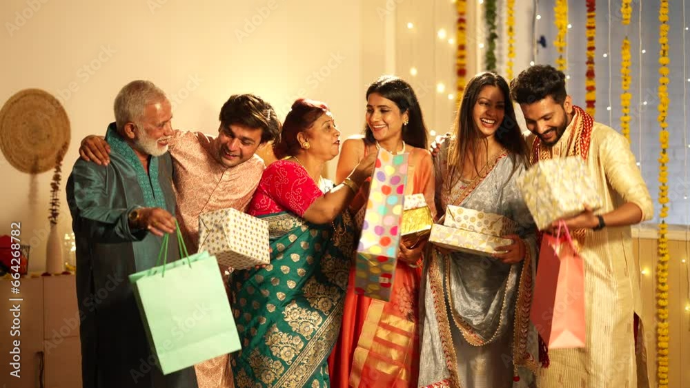 A happy smiling ethnic Indian Hindu family is standing together in ...