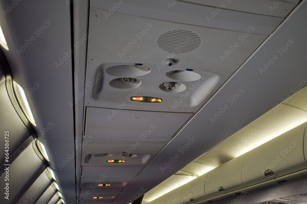 Fasten Seat belt sign and No Smoking sign in the airplane interior. Highlighted symbols ...