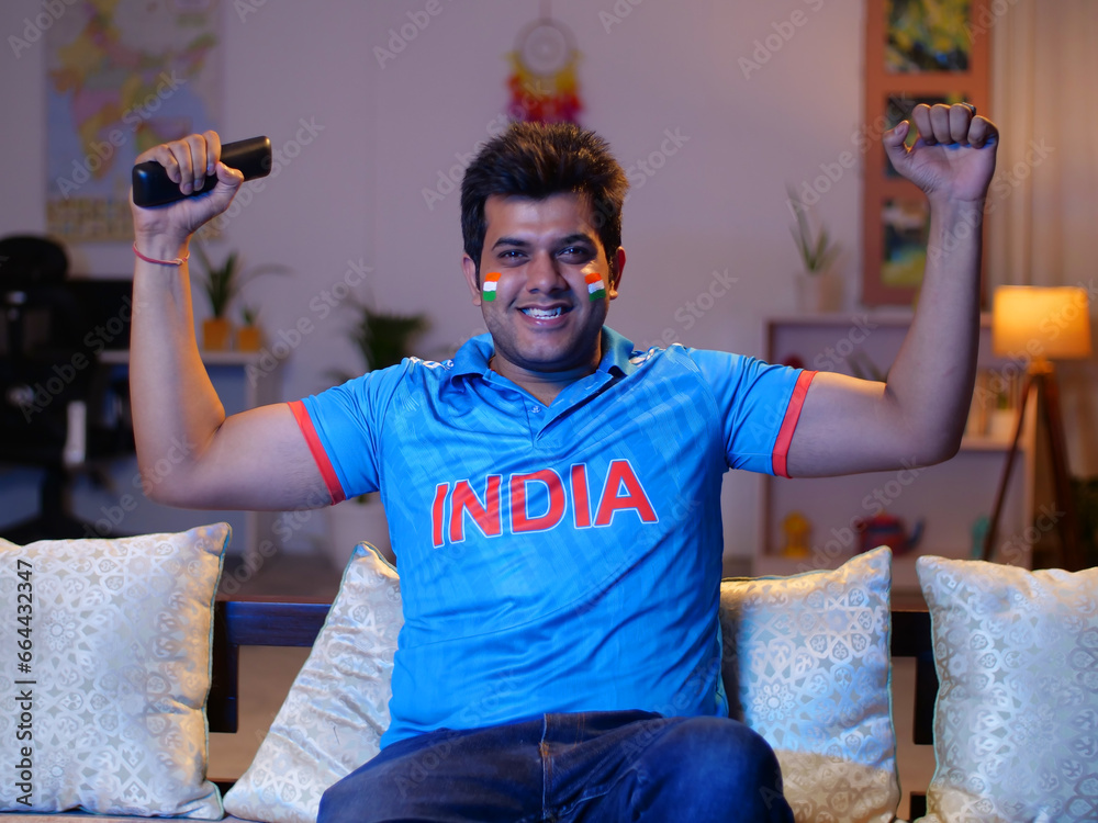 Excited young Indian man wearing cricket jersey - watching cricket ...