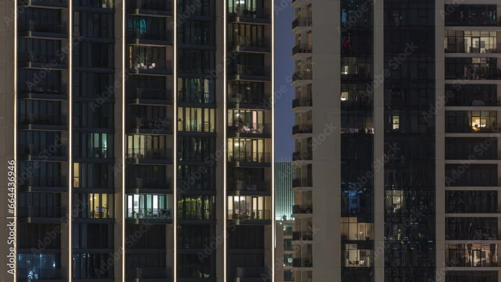 Evening light in rooms in towers and skyscrapers. Tall blocks of flats ...