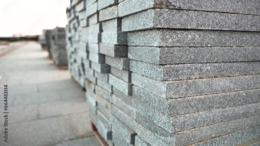 Close up of granite paving slabs planks in a stack on a wooden pallet ...